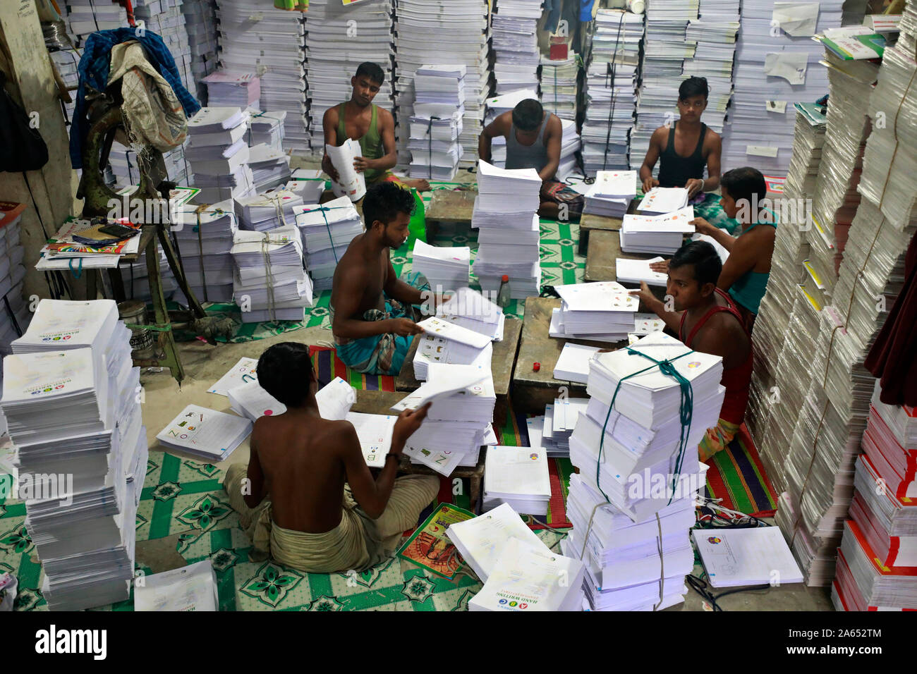 Dhaka, Bangladesh - October 22, 2019. Bangladeshi book binding worker ...