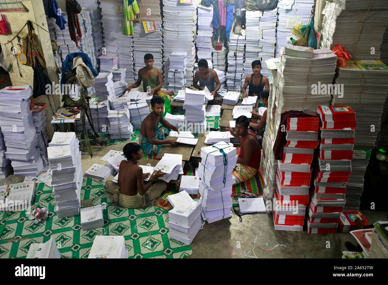 Dhaka, Bangladesh - October 22, 2019. Bangladeshi book binding worker ...