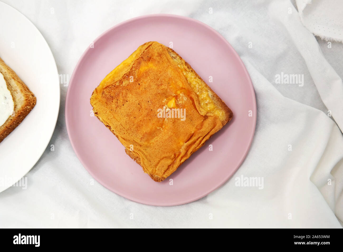 Melted Cheesy Toast Close Up On Pink Dish Stock Photo - Alamy