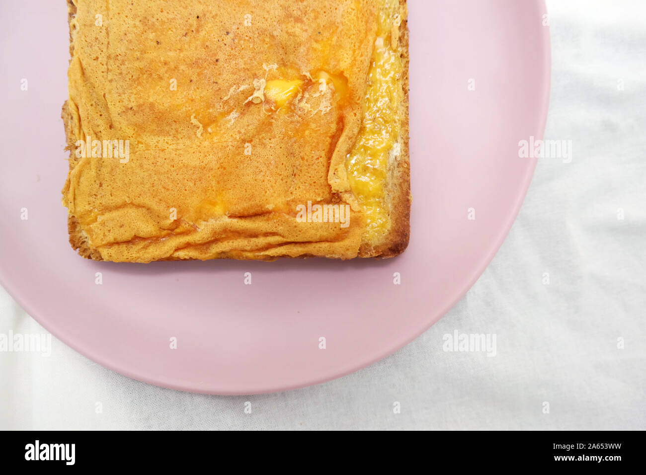 Melted Cheesy Toast Close Up On Pink Dish Stock Photo - Alamy