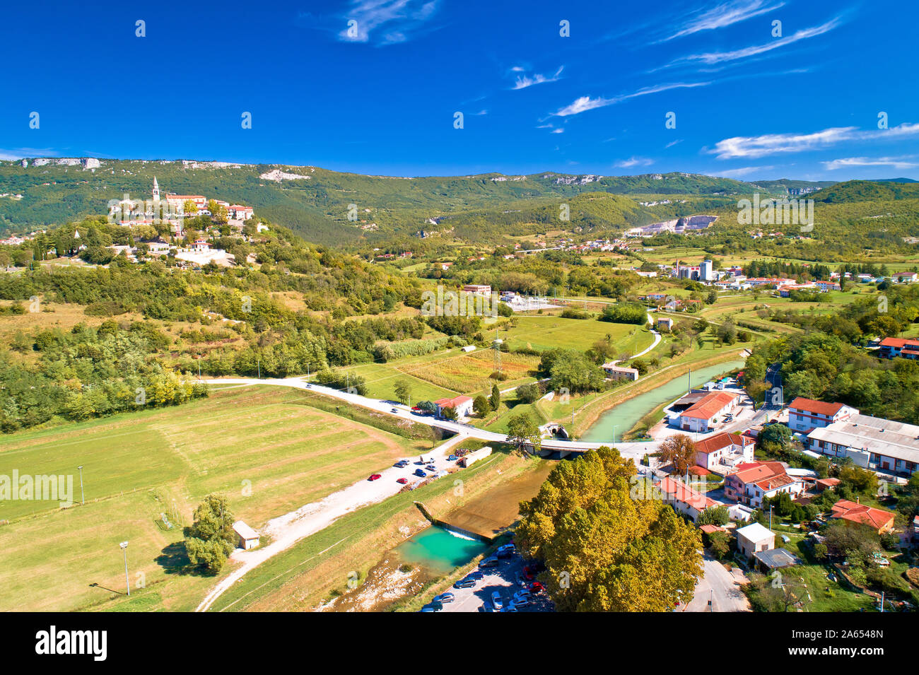 Buzet. Hill town of Buzet and Mirna river in green landscape aerial ...