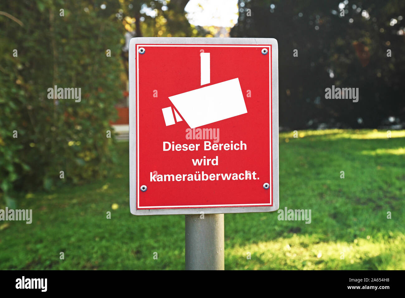 Red warning sign with camare drawing and German text saying 'This area ...