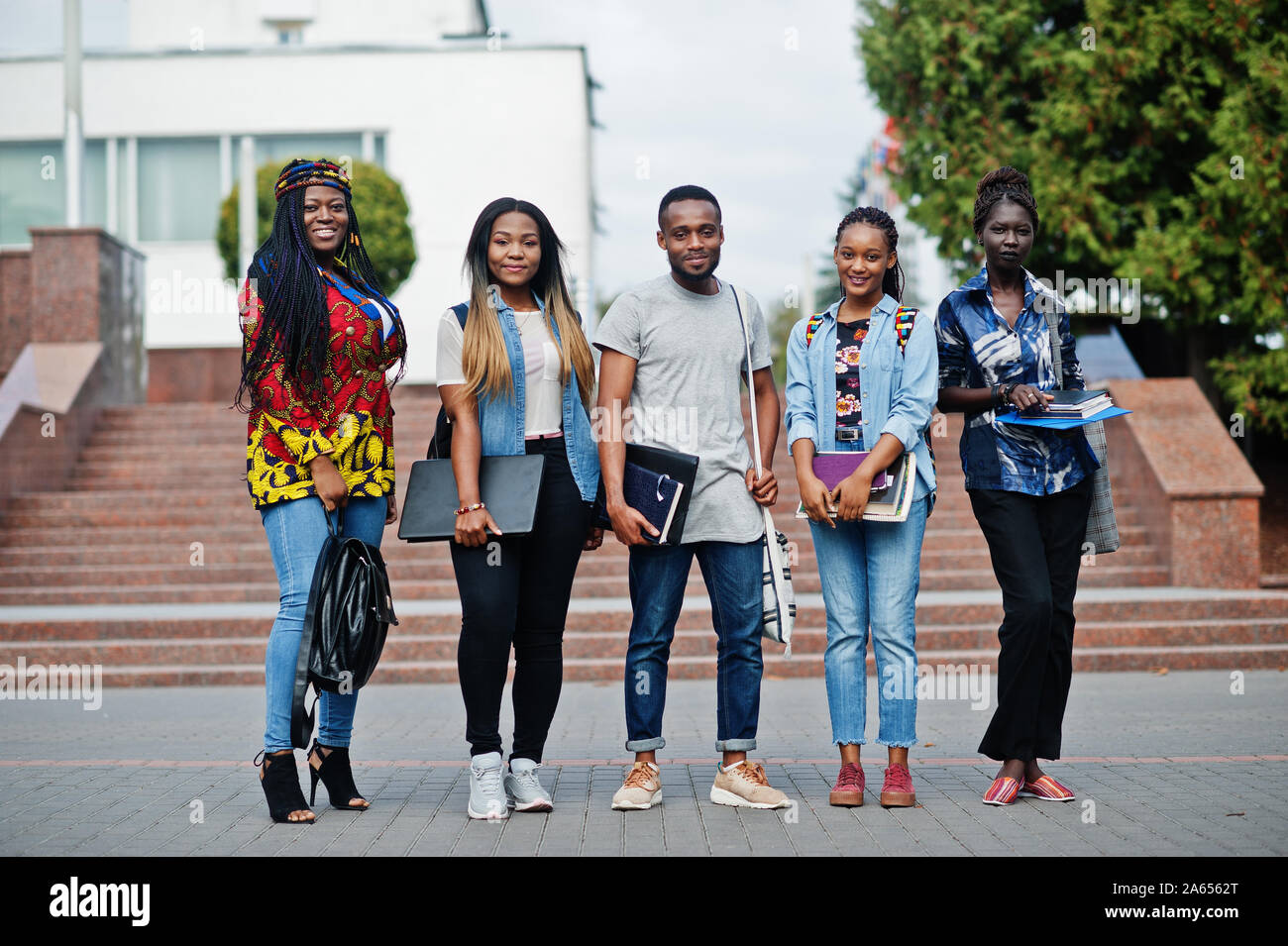 Group of five african college students spending time together on campus ...