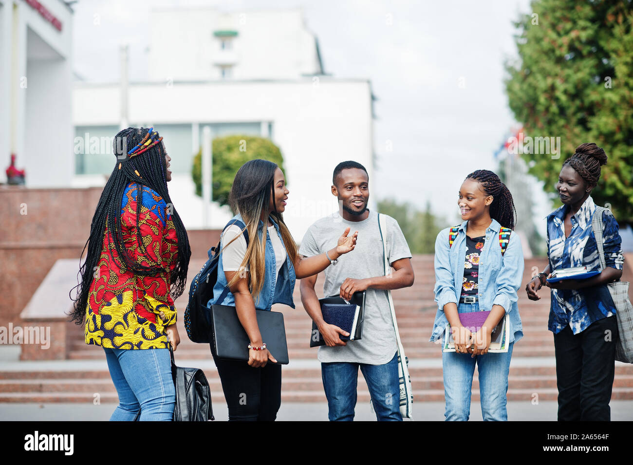 Group of five african college students spending time together on campus ...