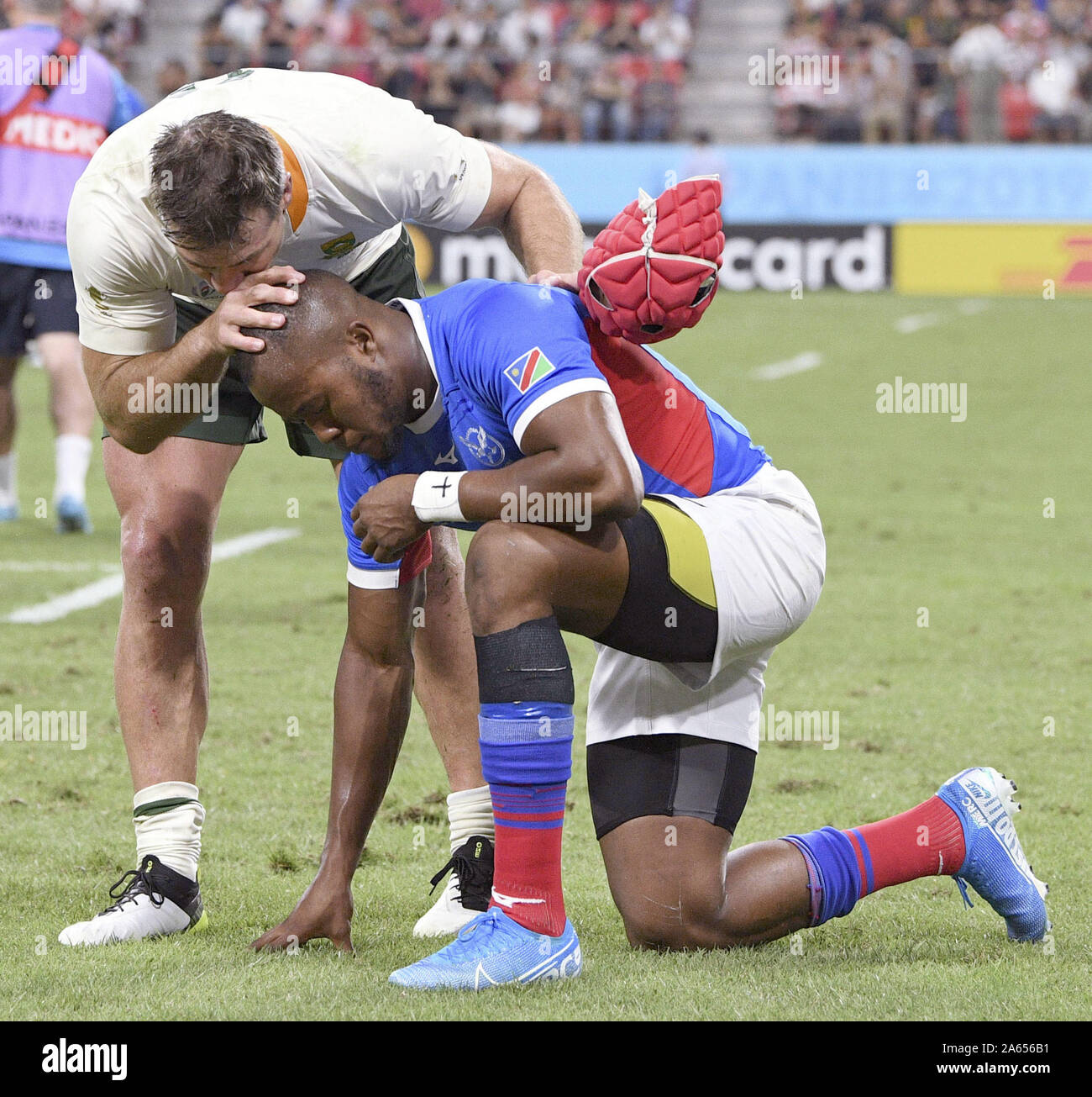 Schalk Brits (top) of South Africa consoles Namibia's Lesley Klim after ...