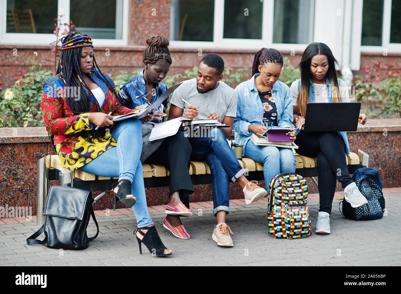 Group of five african college students spending time together on campus ...