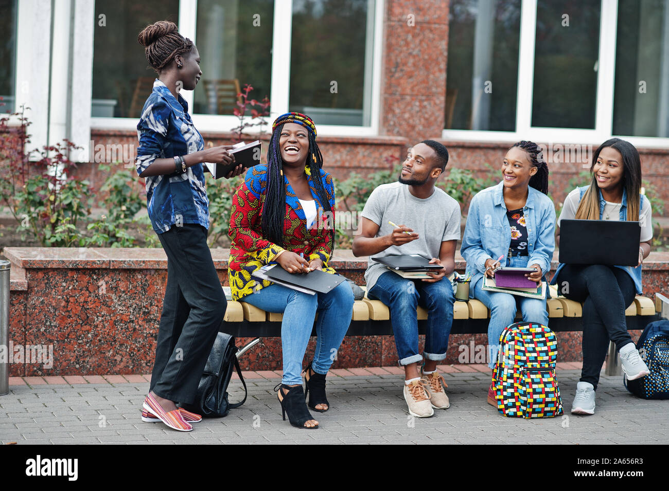Group of five african college students spending time together on campus ...