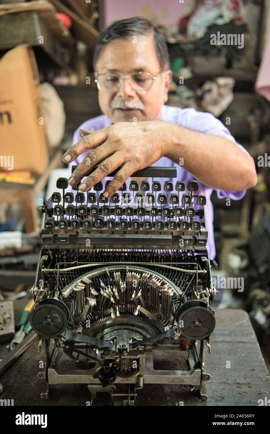 Technician repairing an old manual typewriter, Bombay, Mumbai ...