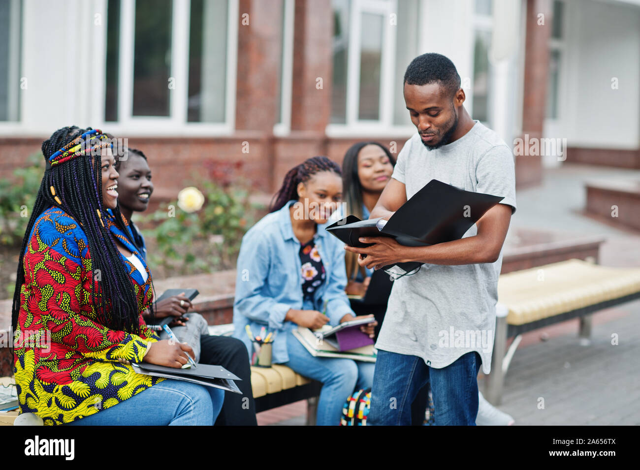 Group of five african college students spending time together on campus ...