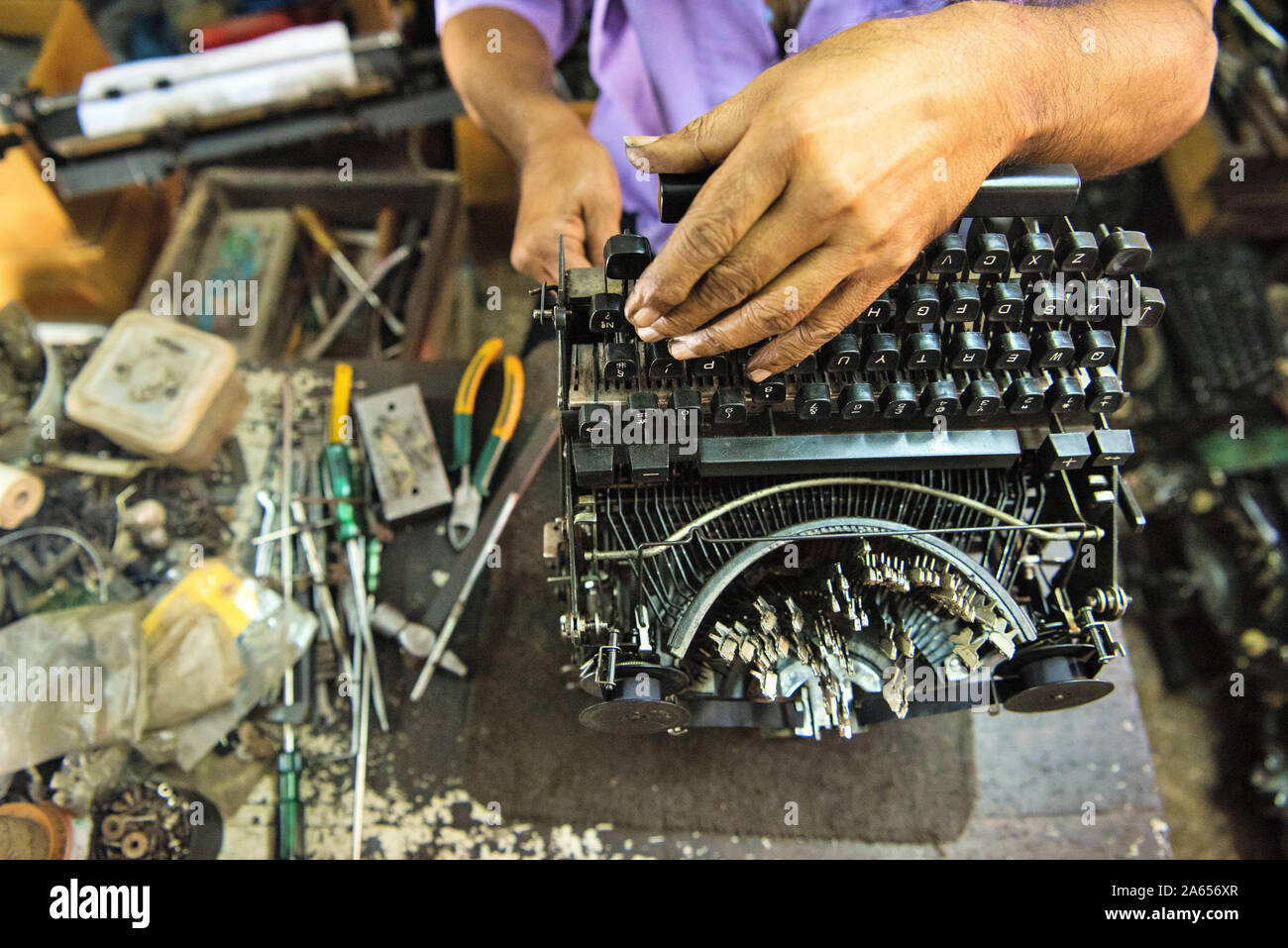 Technician repairing an old manual typewriter, Bombay, Mumbai ...