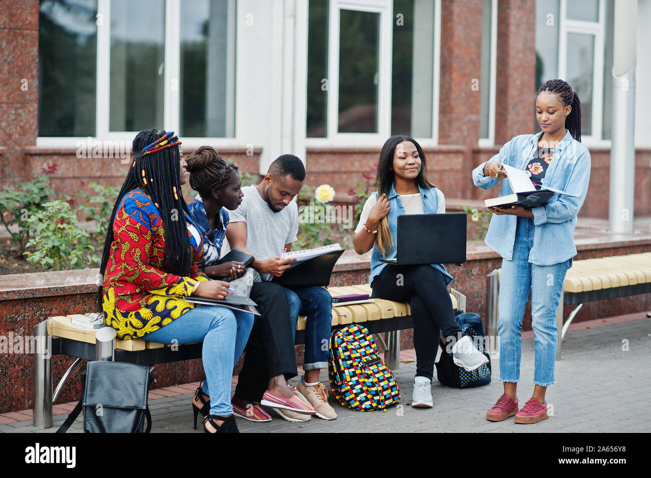 Group of five african college students spending time together on campus ...