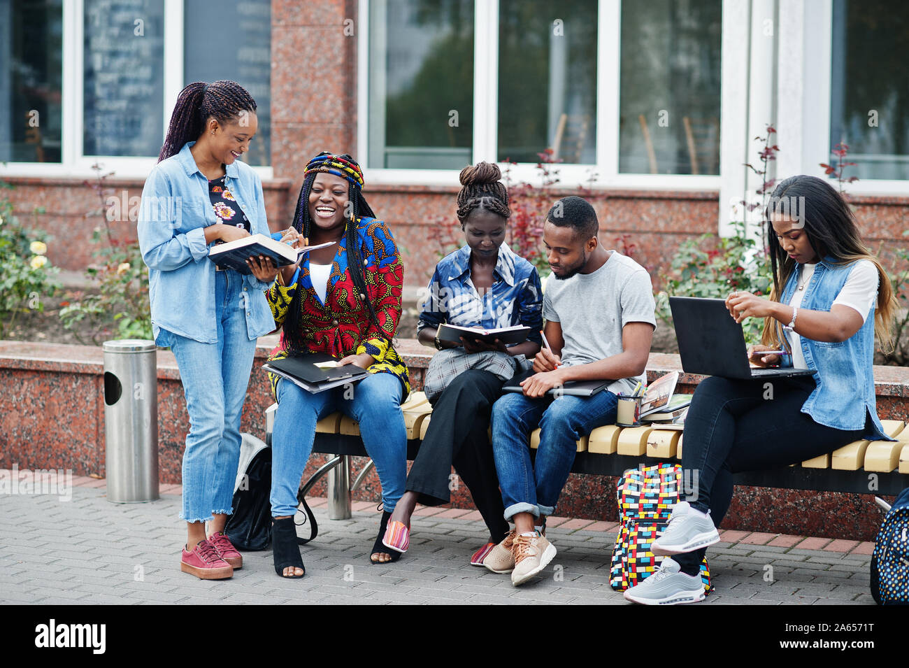 Group of five african college students spending time together on campus ...