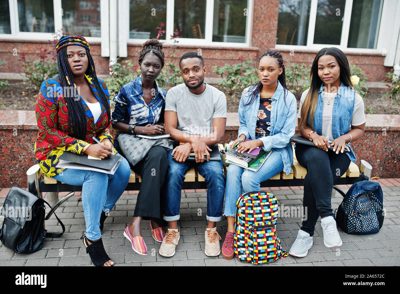 Group of five african college students spending time together on campus ...
