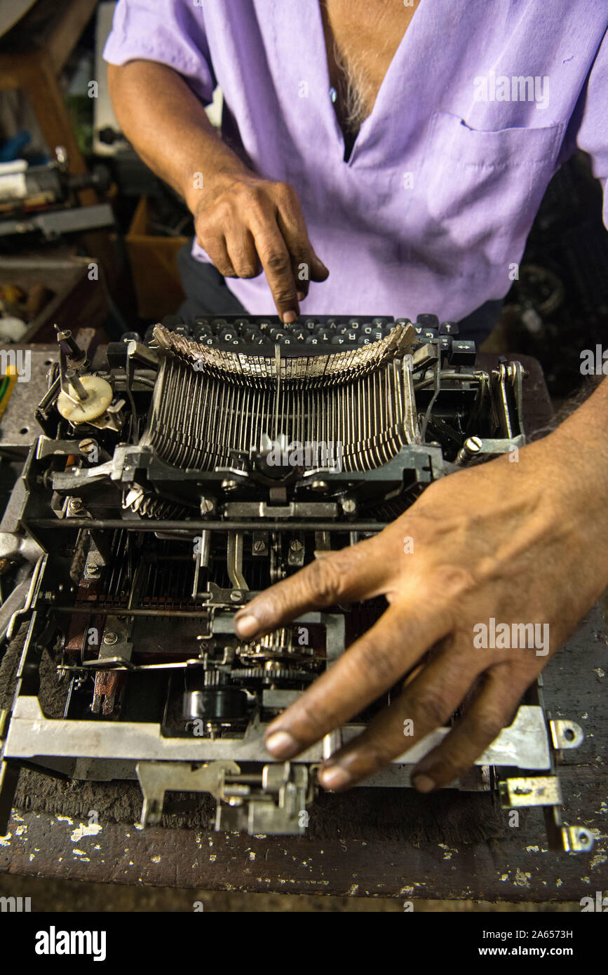 Technician repairing an old manual typewriter, Bombay, Mumbai ...
