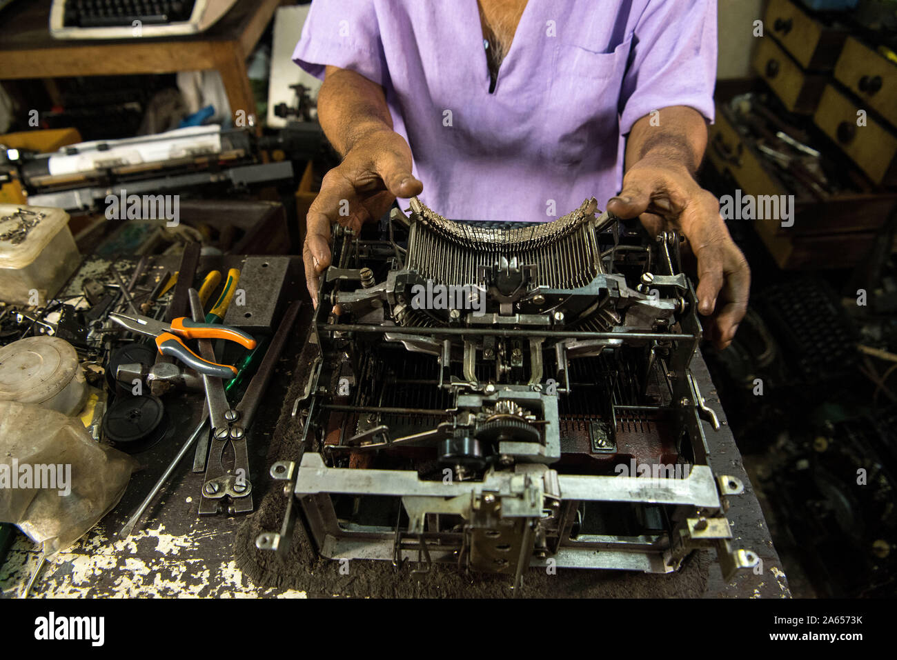 Technician repairing an old manual typewriter, Bombay, Mumbai ...