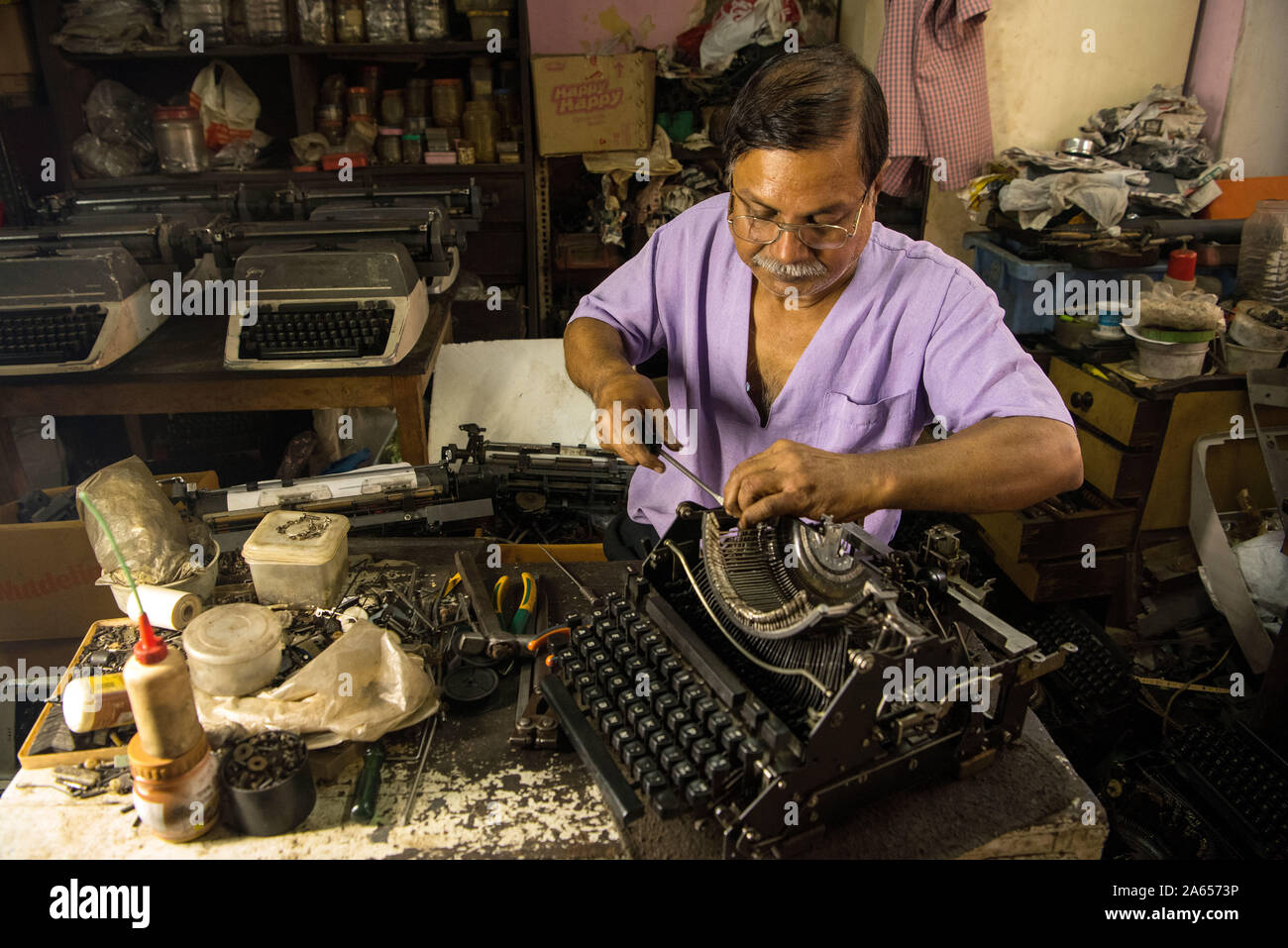 Technician repairing an old manual typewriter, Bombay, Mumbai ...