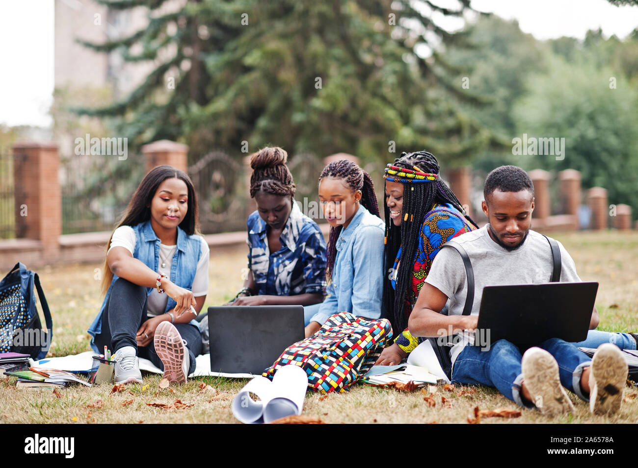 Group of five african college students spending time together on campus ...