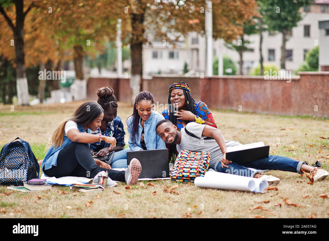 Group of five african college students spending time together on campus ...