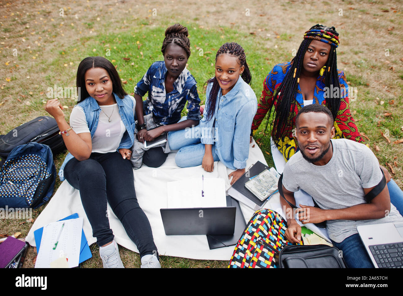Group of five african college students spending time together on campus ...