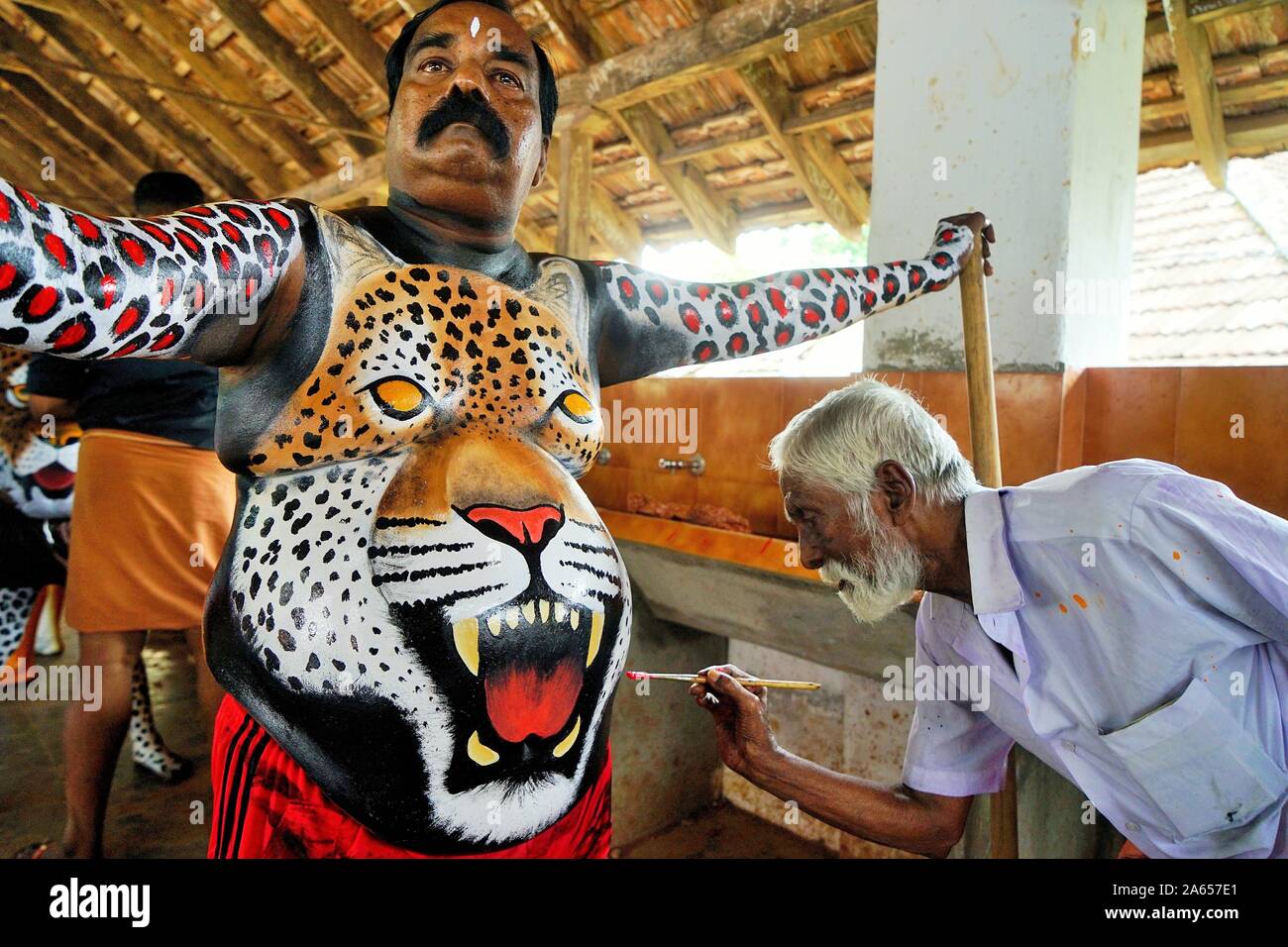 Artists painting bodies for Pulikali Tiger Dance, Onam festival ...