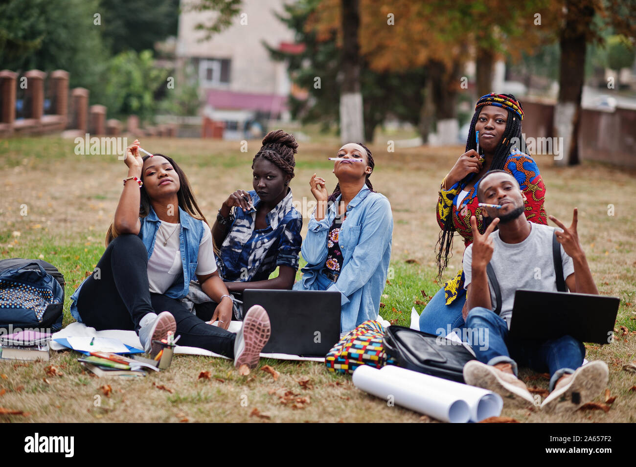 Group of five african college students spending time together on campus ...