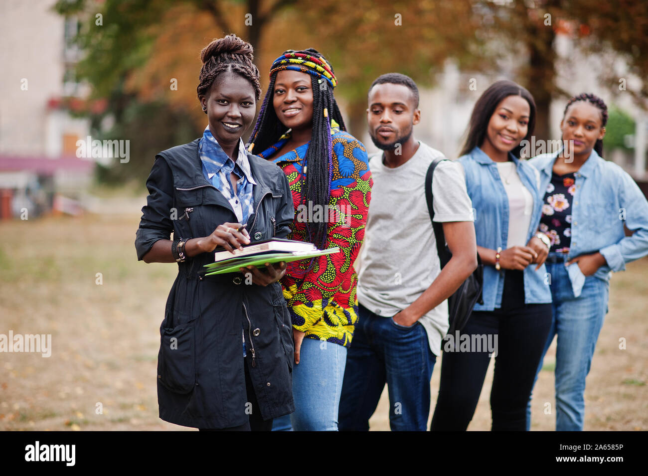 Row of group five african college students spending time together on ...
