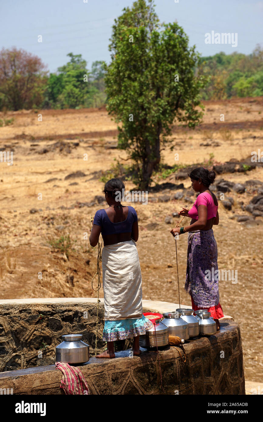 Women collecting water from well at Dhakne village, Shahapur Thane ...