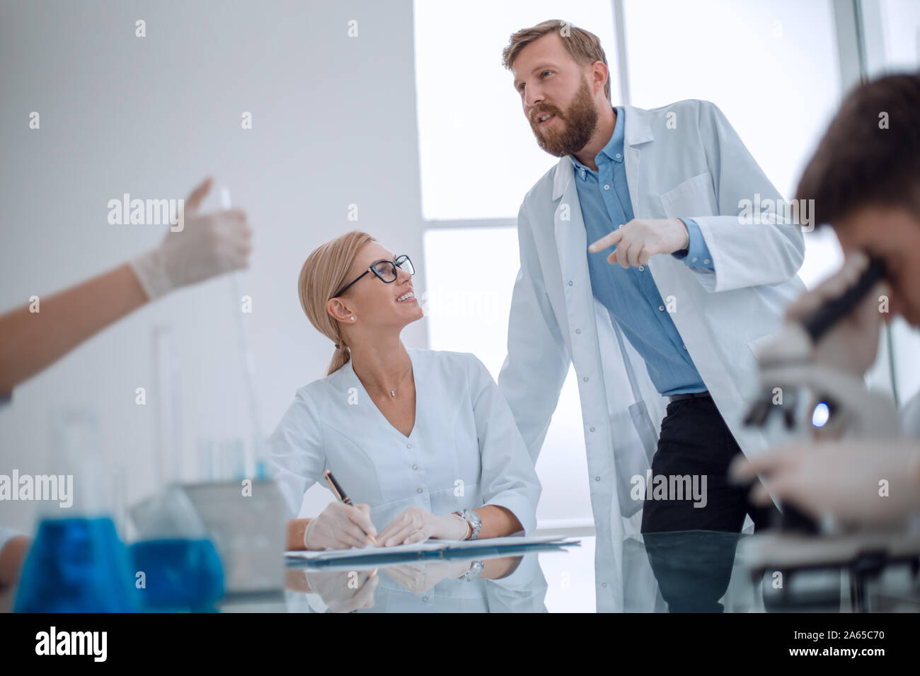female scientist taking notes in a laboratory journal Stock Photo - Alamy