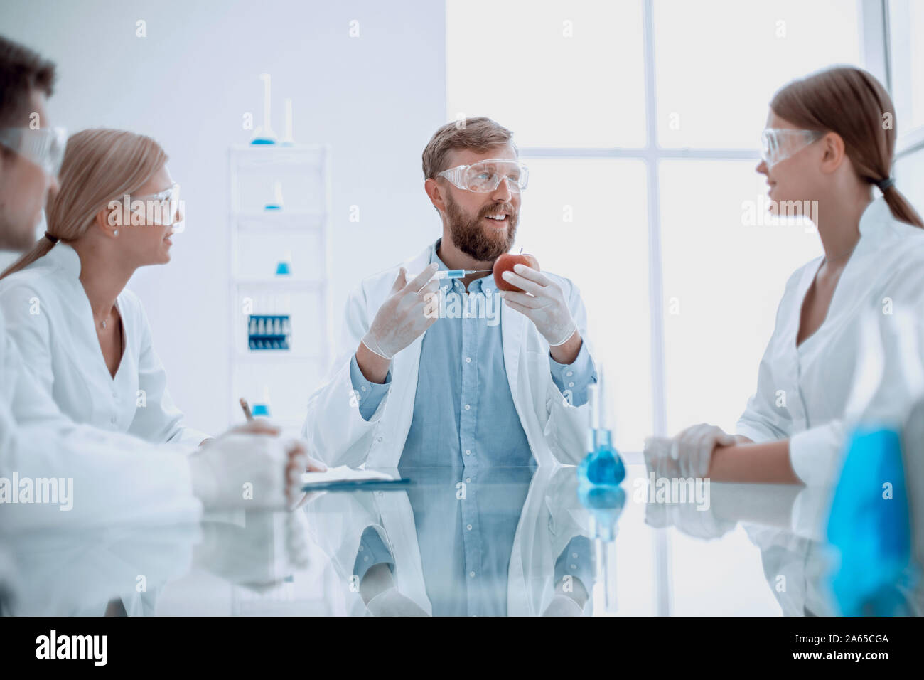 group of experts testing fruits for the presence of GMOs Stock Photo ...