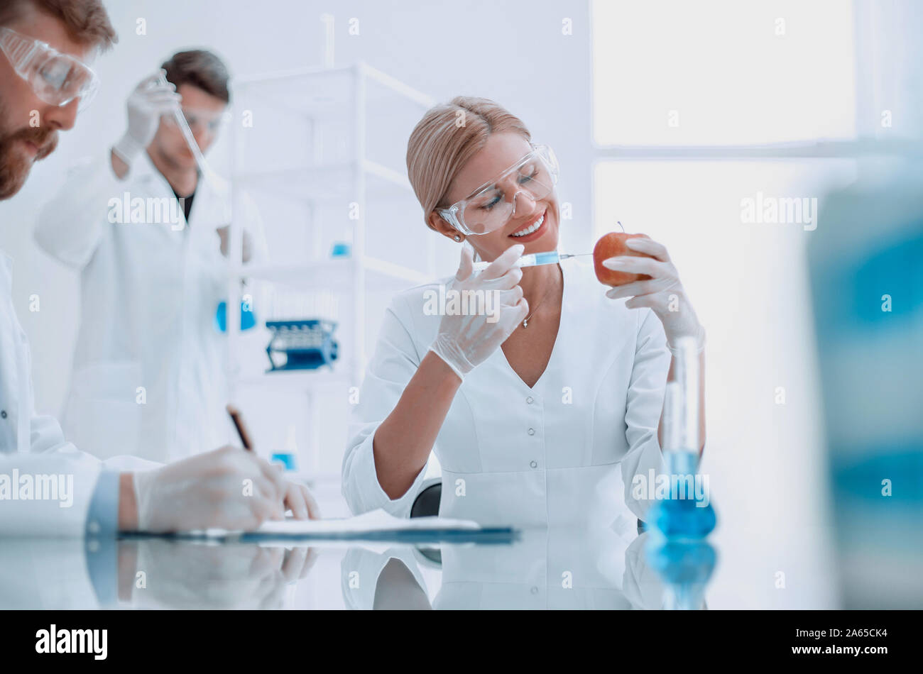 Food quality control. a group of scientists testing the fruit Stock ...