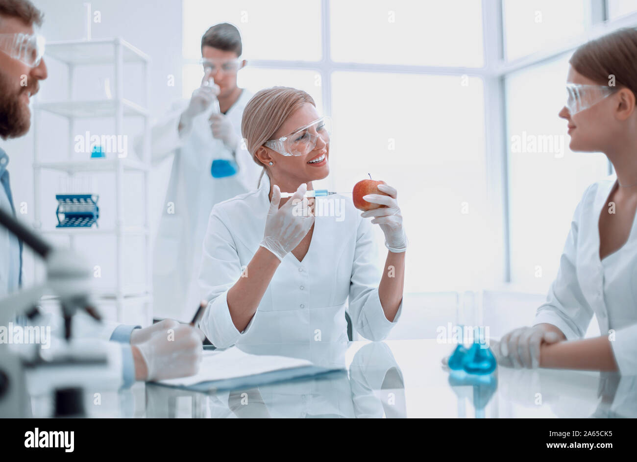 Food quality control. a group of scientists testing the fruit Stock ...