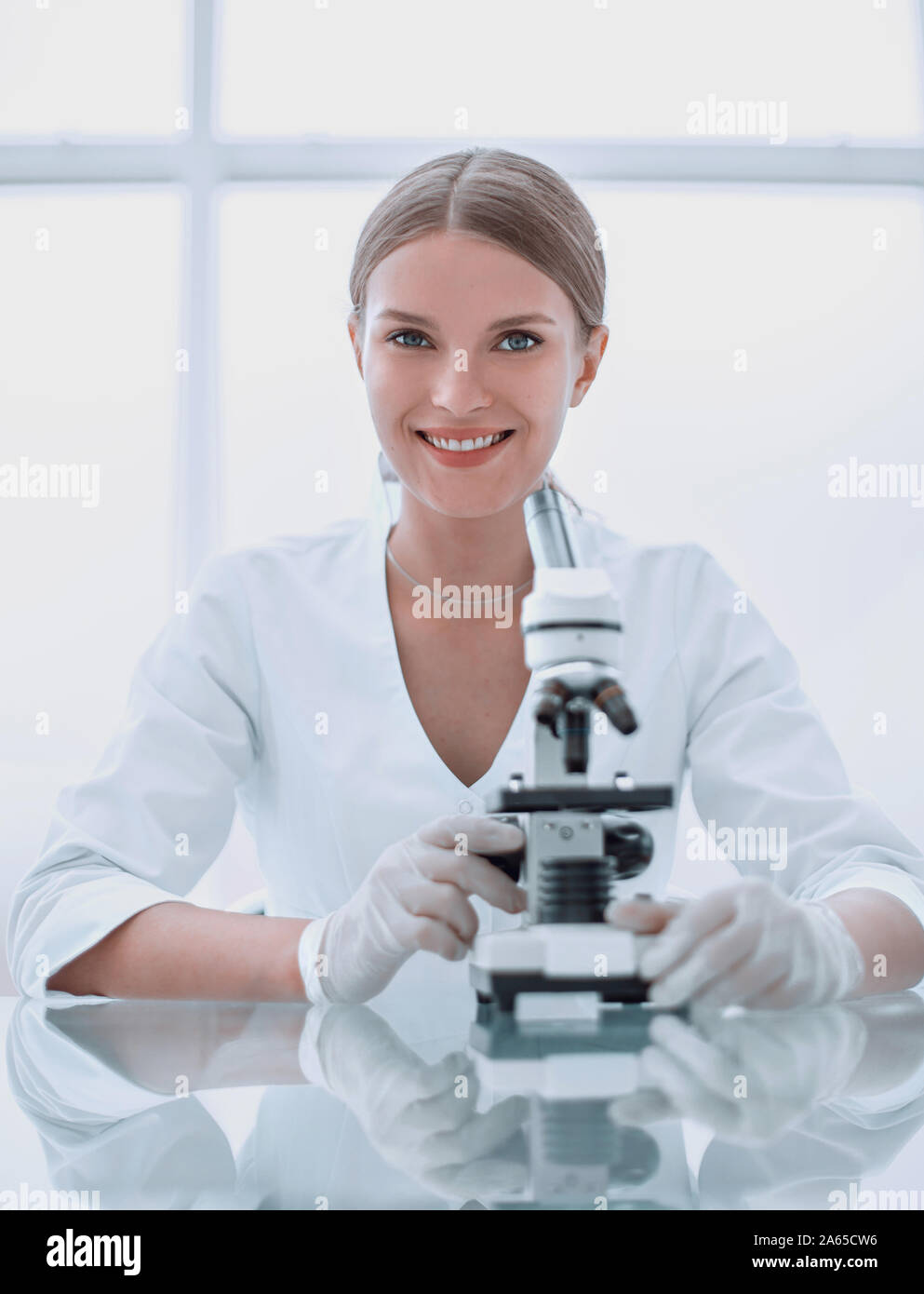 female scientist with a microscope works in the laboratory Stock Photo ...