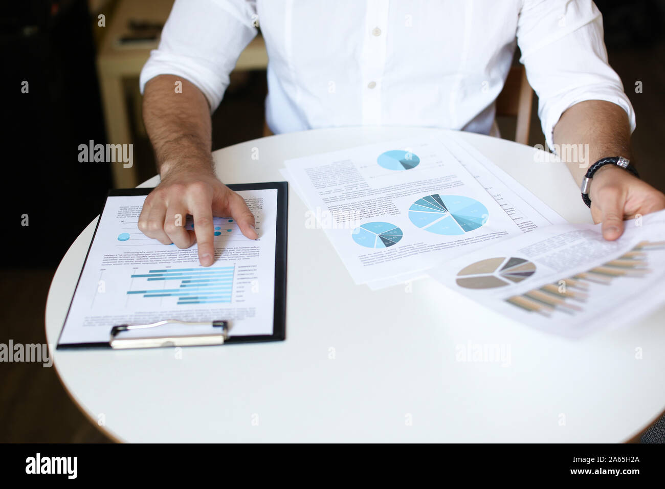 Male caucasian person working with documents and diagrams Stock Photo ...