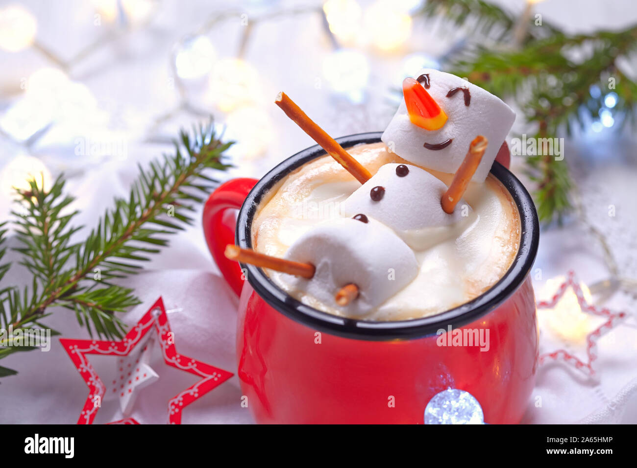 Red mug with hot chocolate with melted marshmallow snowman Stock Photo ...