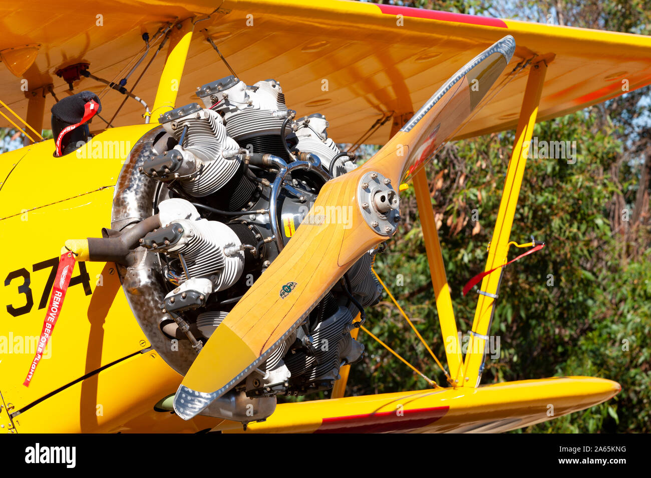 Vintage biplane with a 7 cylinder radial engine with a wooden propeller ...