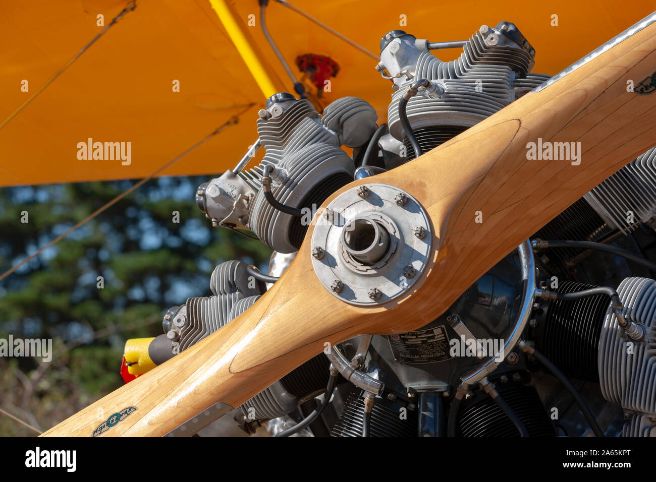 Vintage biplane with a 7 cylinder radial engine with a wooden propeller ...