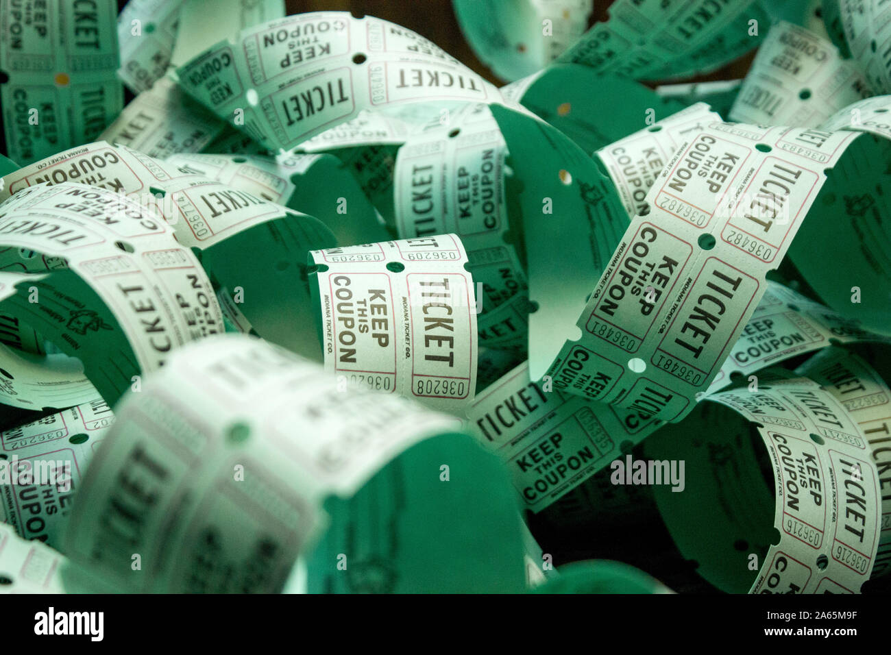Roll of green raffle tickets unrolled for use in lottery and raffle ...