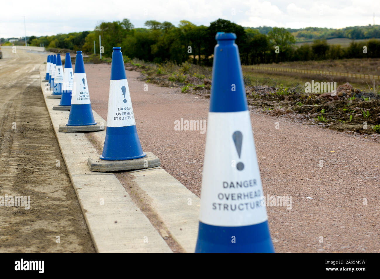 Motorway construction with a row of blue and white raod cones advising ...