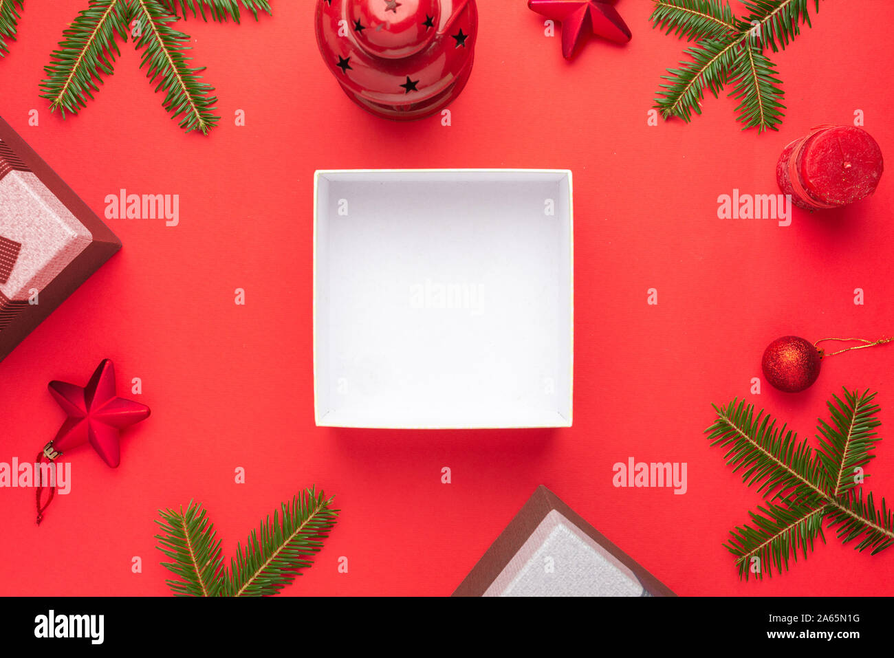 Empty gift box for product presentation on red surface surrounded with ...