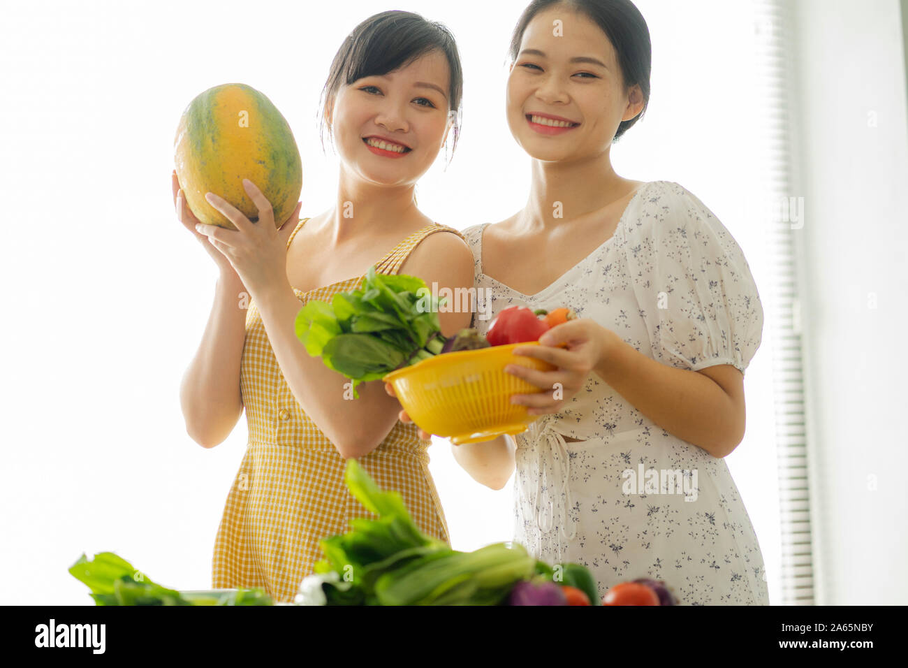 Pretty girls cooking in the kitchen Stock Photo - Alamy