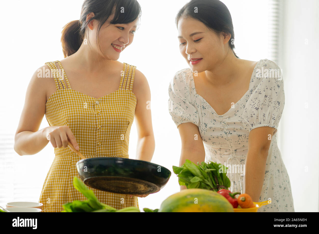 Pretty girls cooking in the kitchen Stock Photo - Alamy