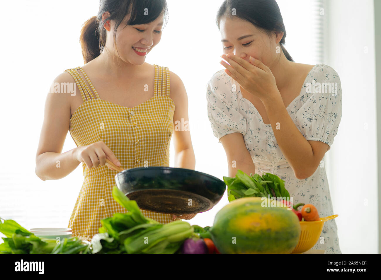 Pretty girls cooking in the kitchen Stock Photo - Alamy