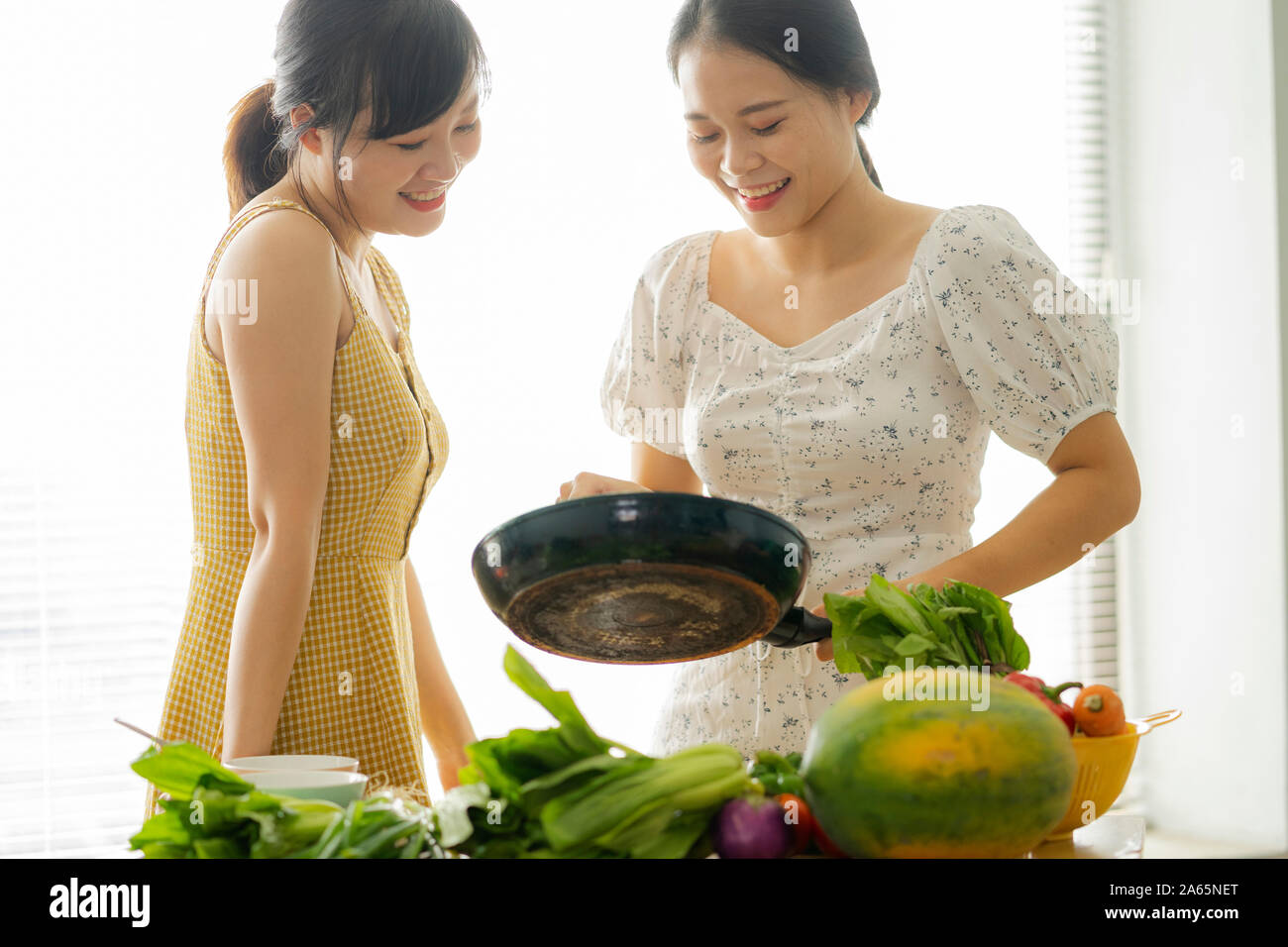 Pretty girls cooking in the kitchen Stock Photo - Alamy