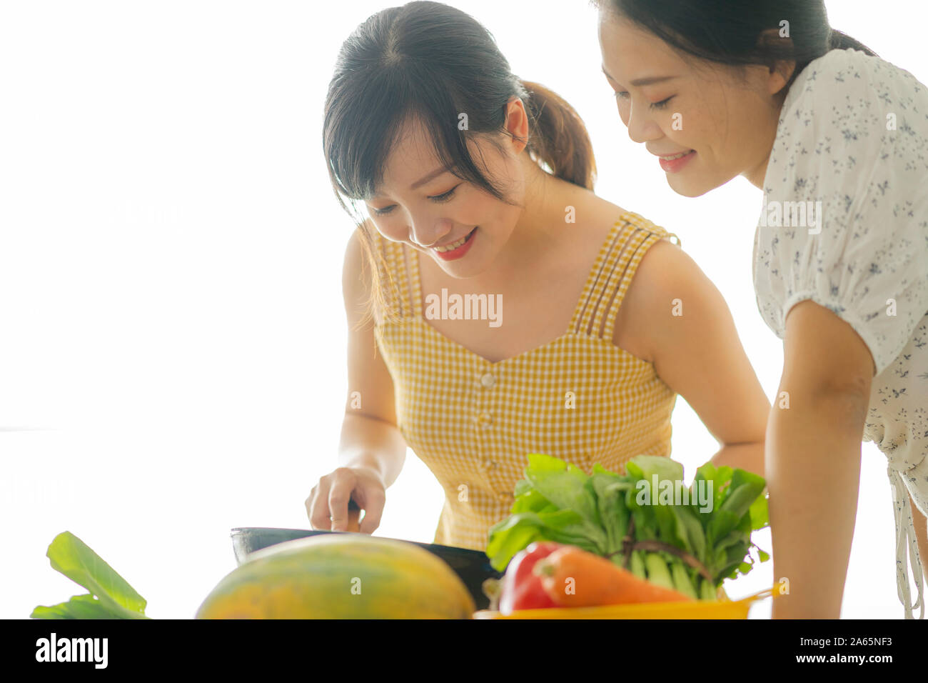 Pretty girls cooking in the kitchen Stock Photo - Alamy