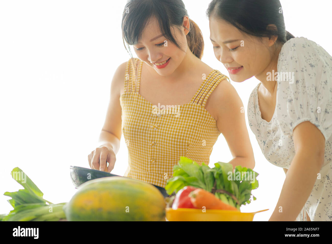 Pretty girls cooking in the kitchen Stock Photo - Alamy