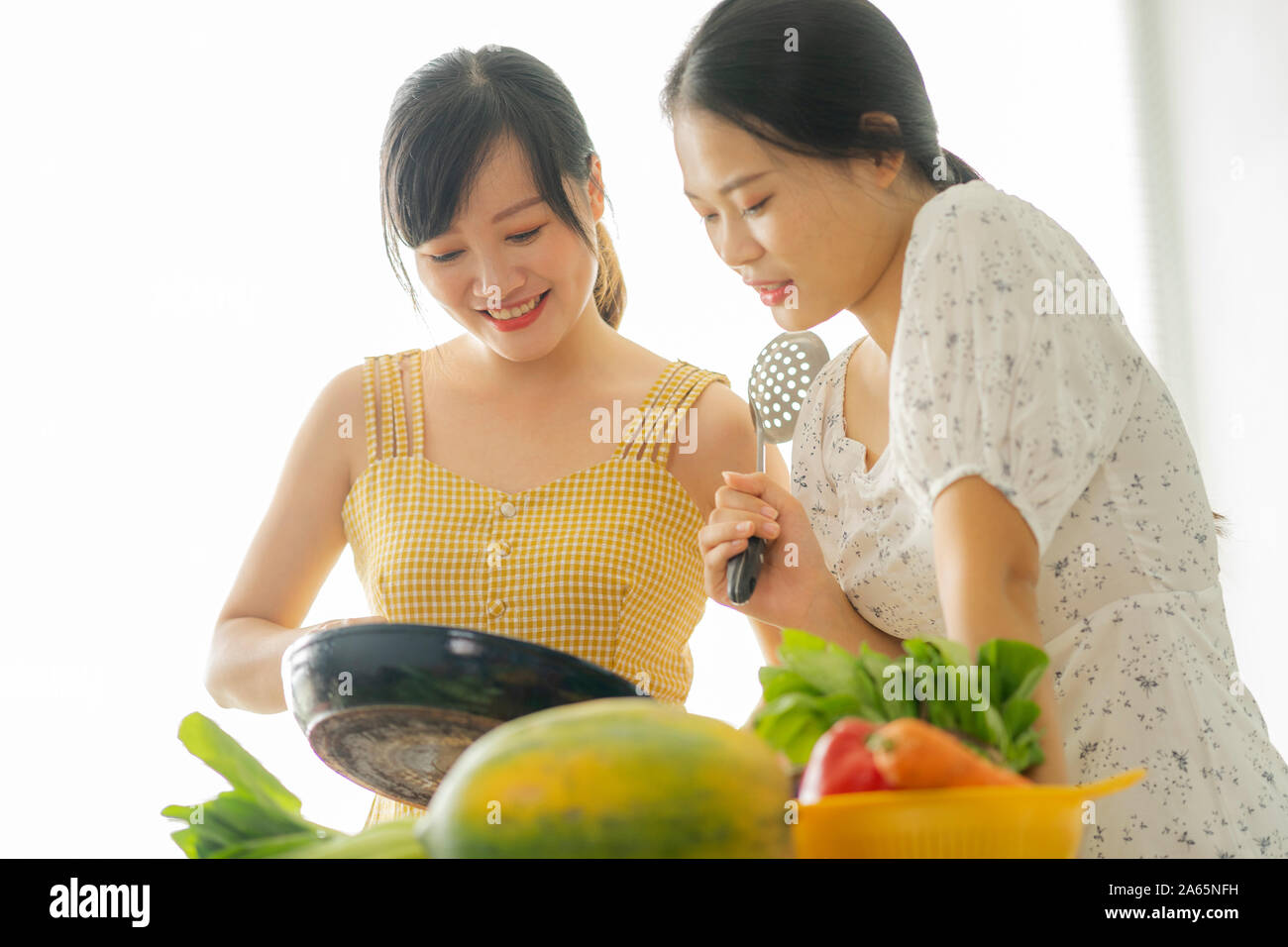 Pretty girls cooking in the kitchen Stock Photo - Alamy
