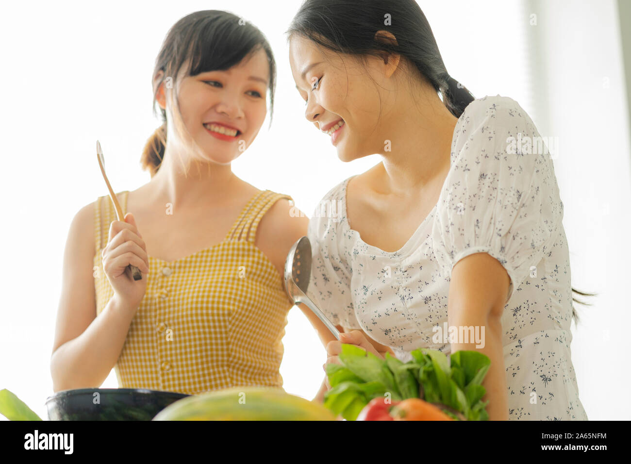 Pretty girls cooking in the kitchen Stock Photo - Alamy