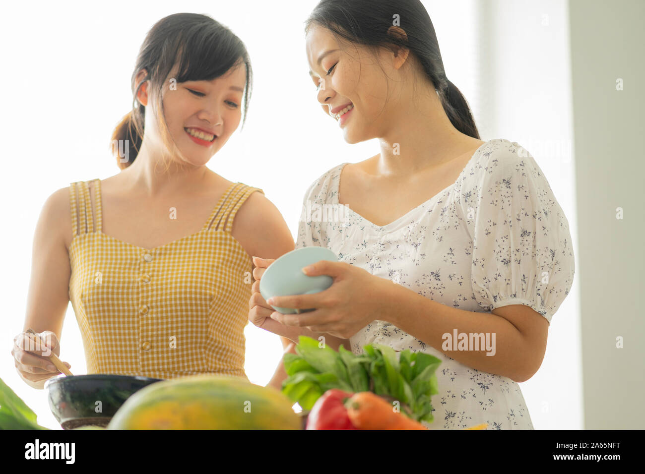 Pretty girls cooking in the kitchen Stock Photo - Alamy