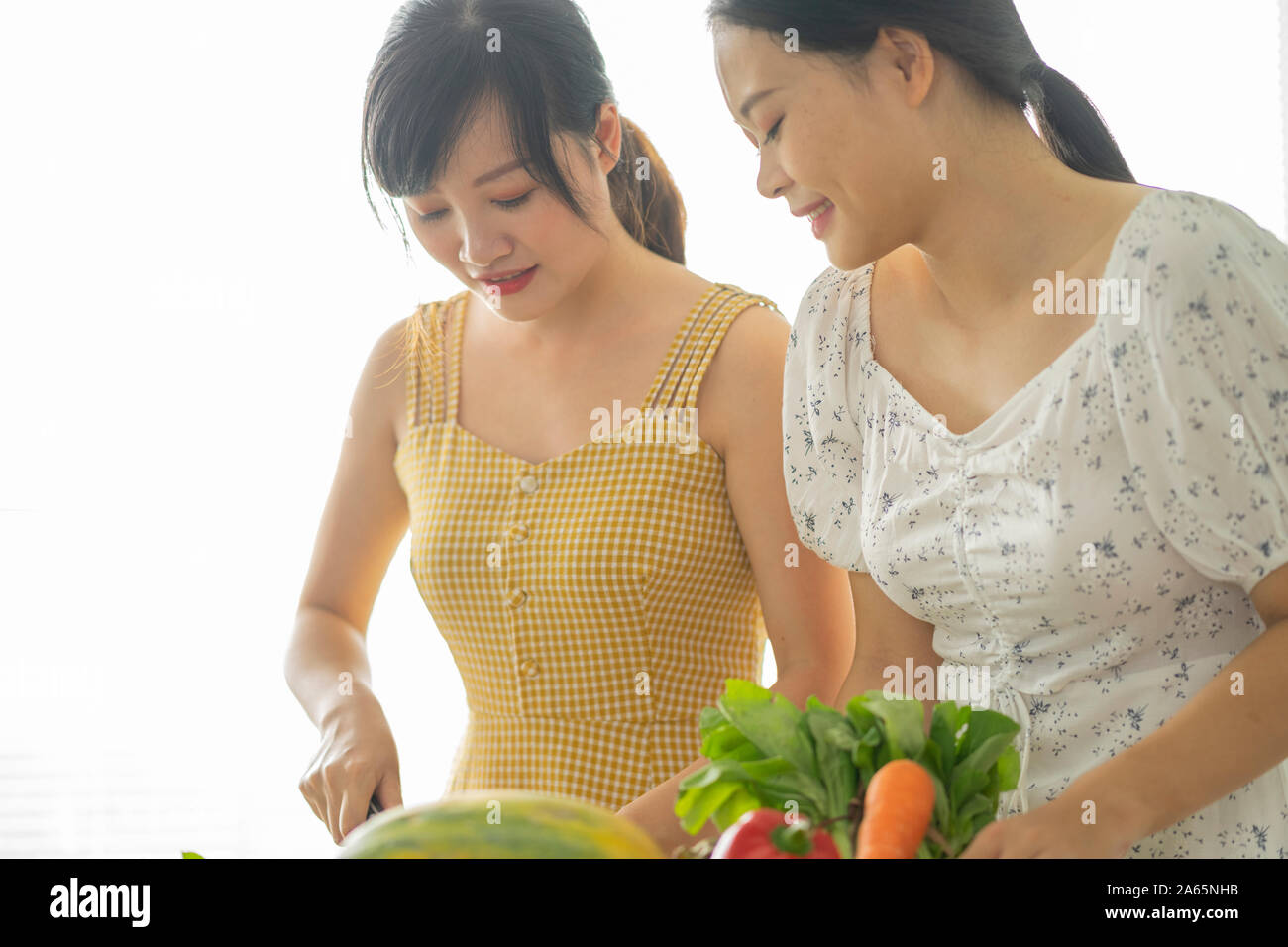 Pretty girls cooking in the kitchen Stock Photo - Alamy