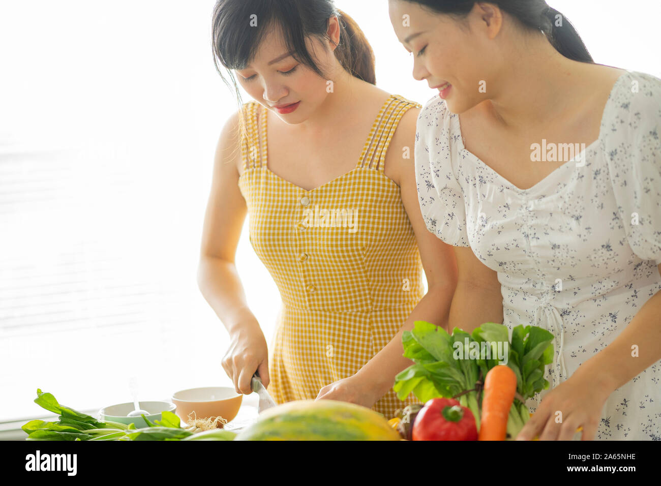 Pretty girls cooking in the kitchen Stock Photo - Alamy